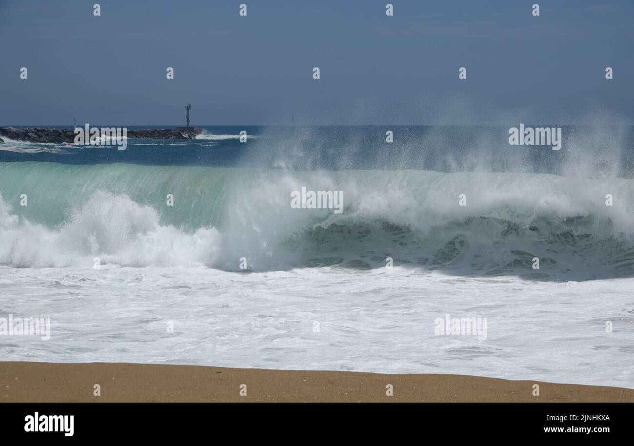 powerful wave crashing on beach in Newport Stock Photo - Alamy