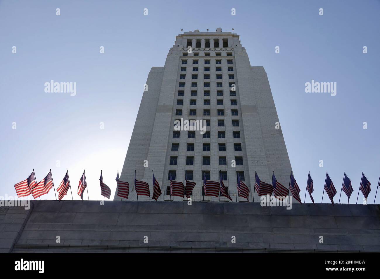 Los Angeles City Hall with flags waving in the breeze Stock Photo - Alamy
