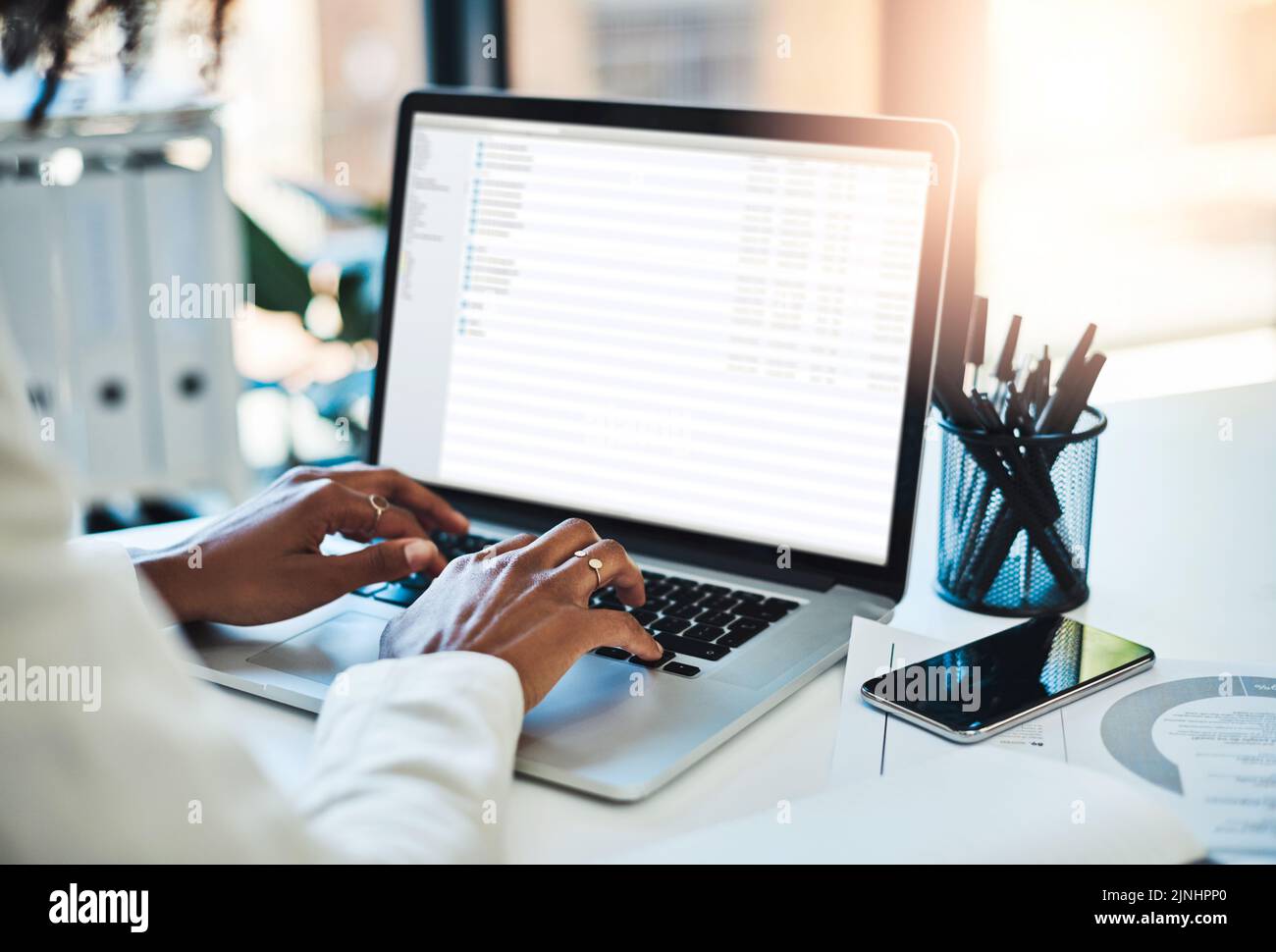 Tech savvy and successful. an unrecognizable woman working on a laptop ...