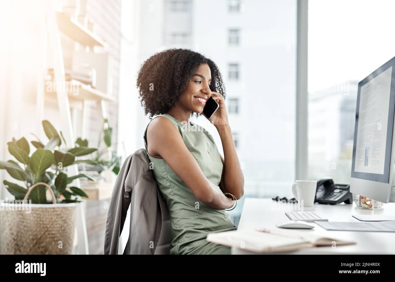 Those make it happen calls. a young businesswoman using a mobile phone ...