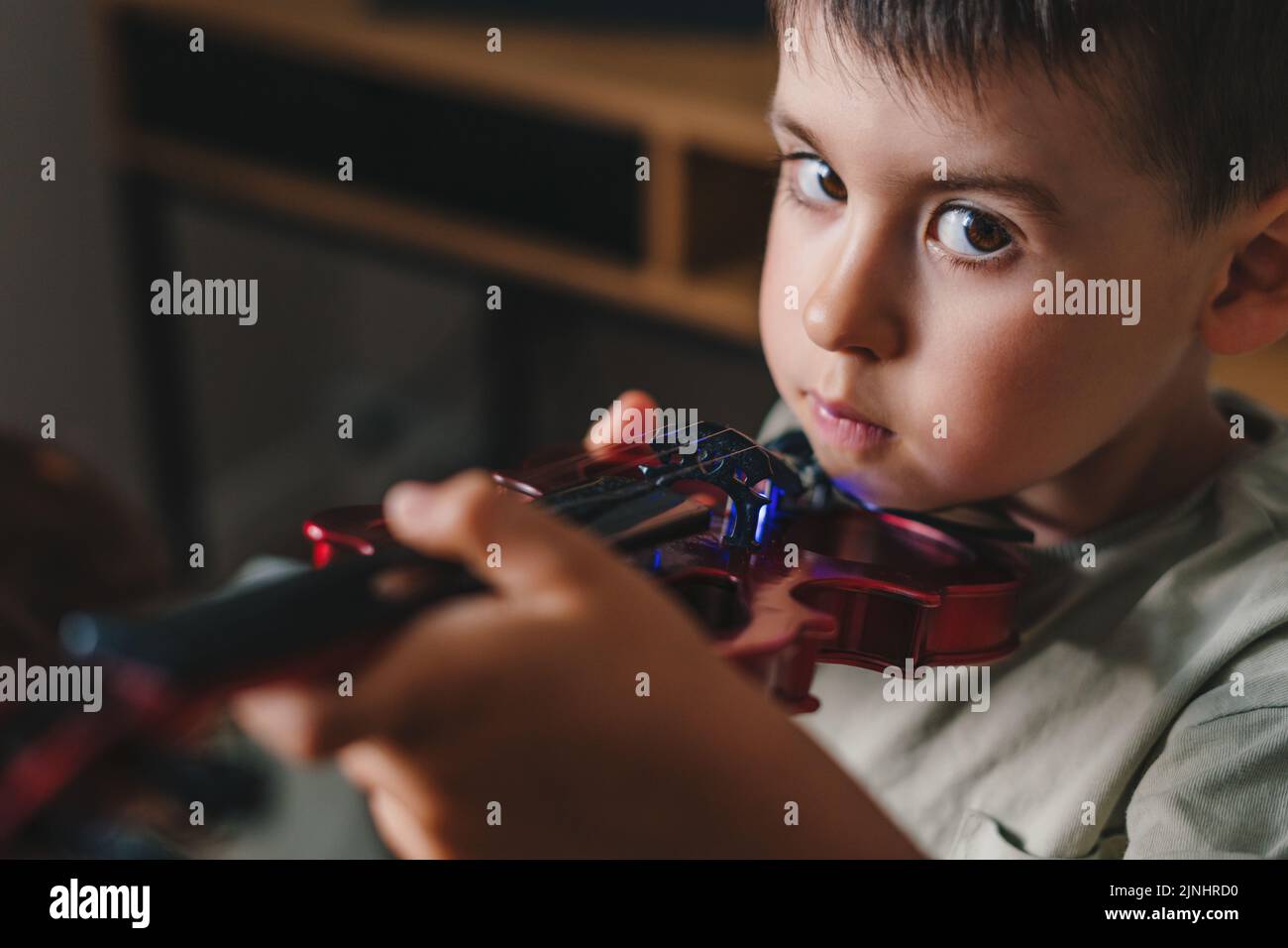 Portrait of a little boy playing violin. Child with music instruments ...