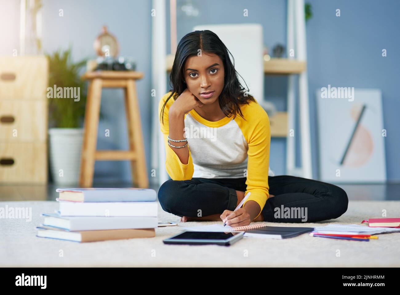This is how I prep for finals. a young female student studying at home ...