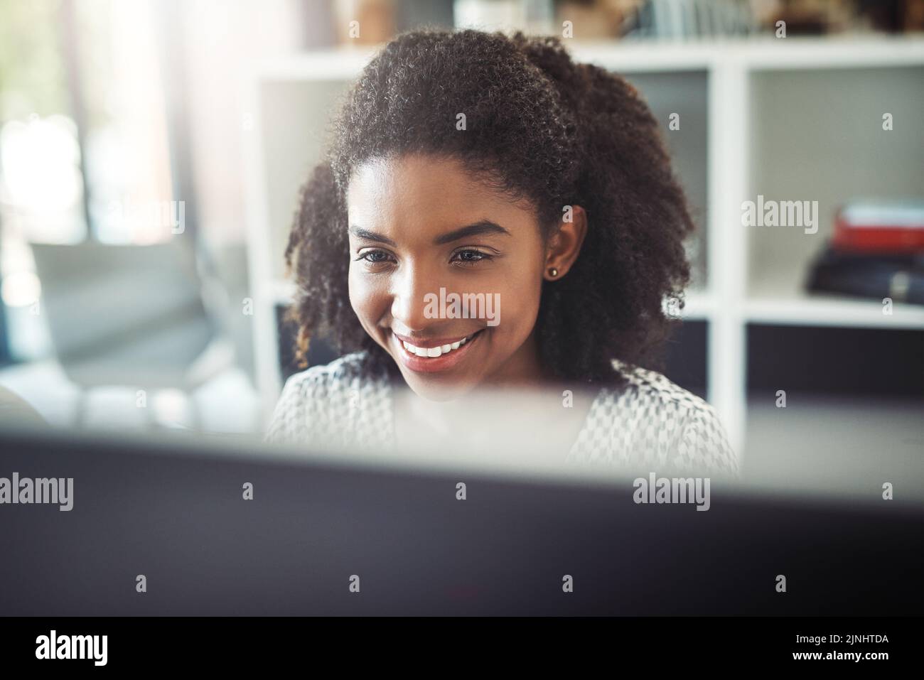 She does everything with a smile on her face. a young businesswoman ...