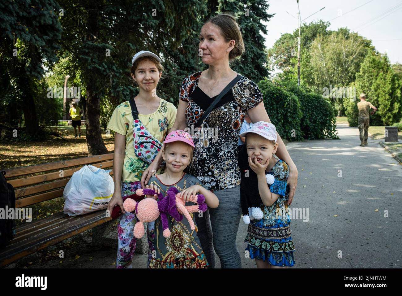 A mother and her children seen waiting to board an evacuation vehicle ...