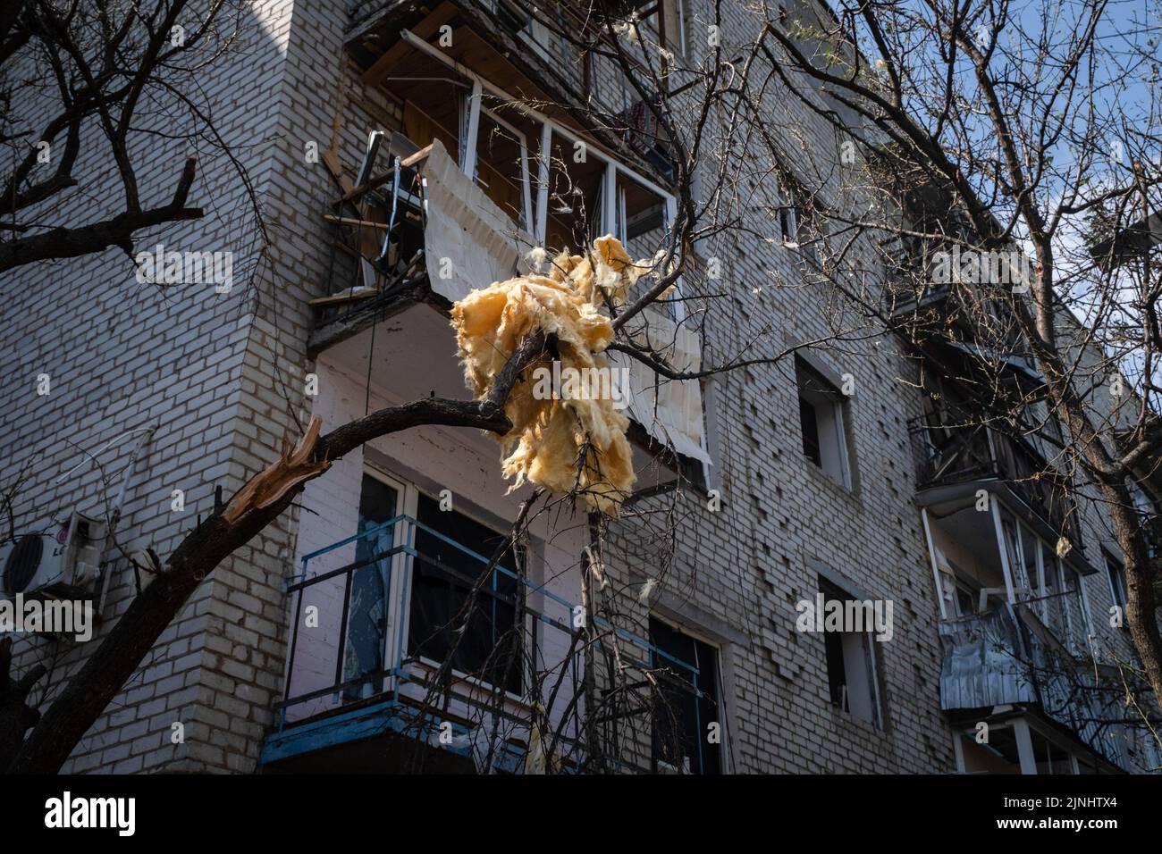 A wall building material blown up seen hanging on the tree after a ...