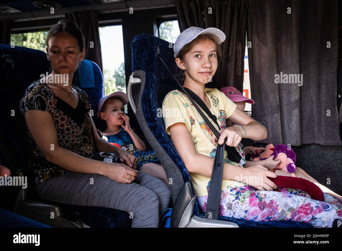 Children seen on an evacuation bus with their mother in Slovyansk. Amid ...