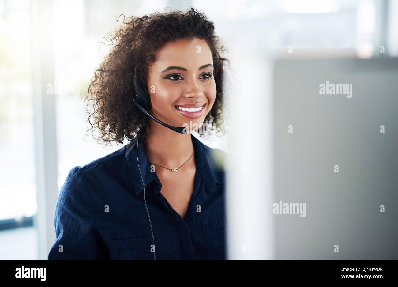 Problem solving makes her smile grow wider. an attractive young female ...