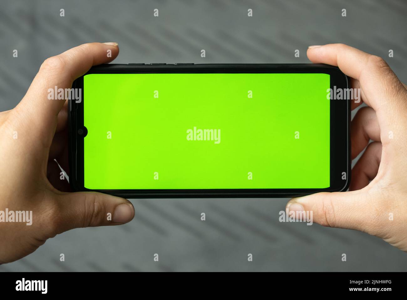 mobile phone with green chroma key on touch screen in woman hands Stock ...