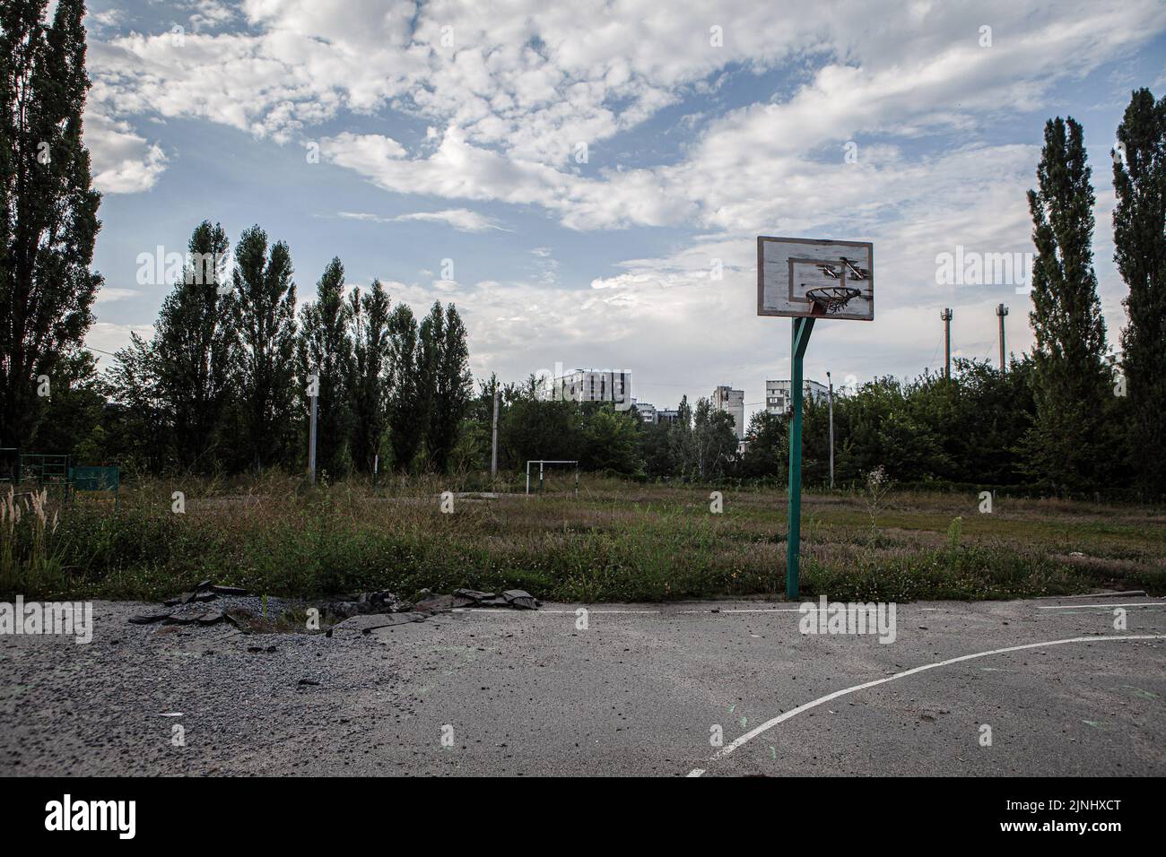 A crater from shelling on a basketball court in the North Saltivka ...