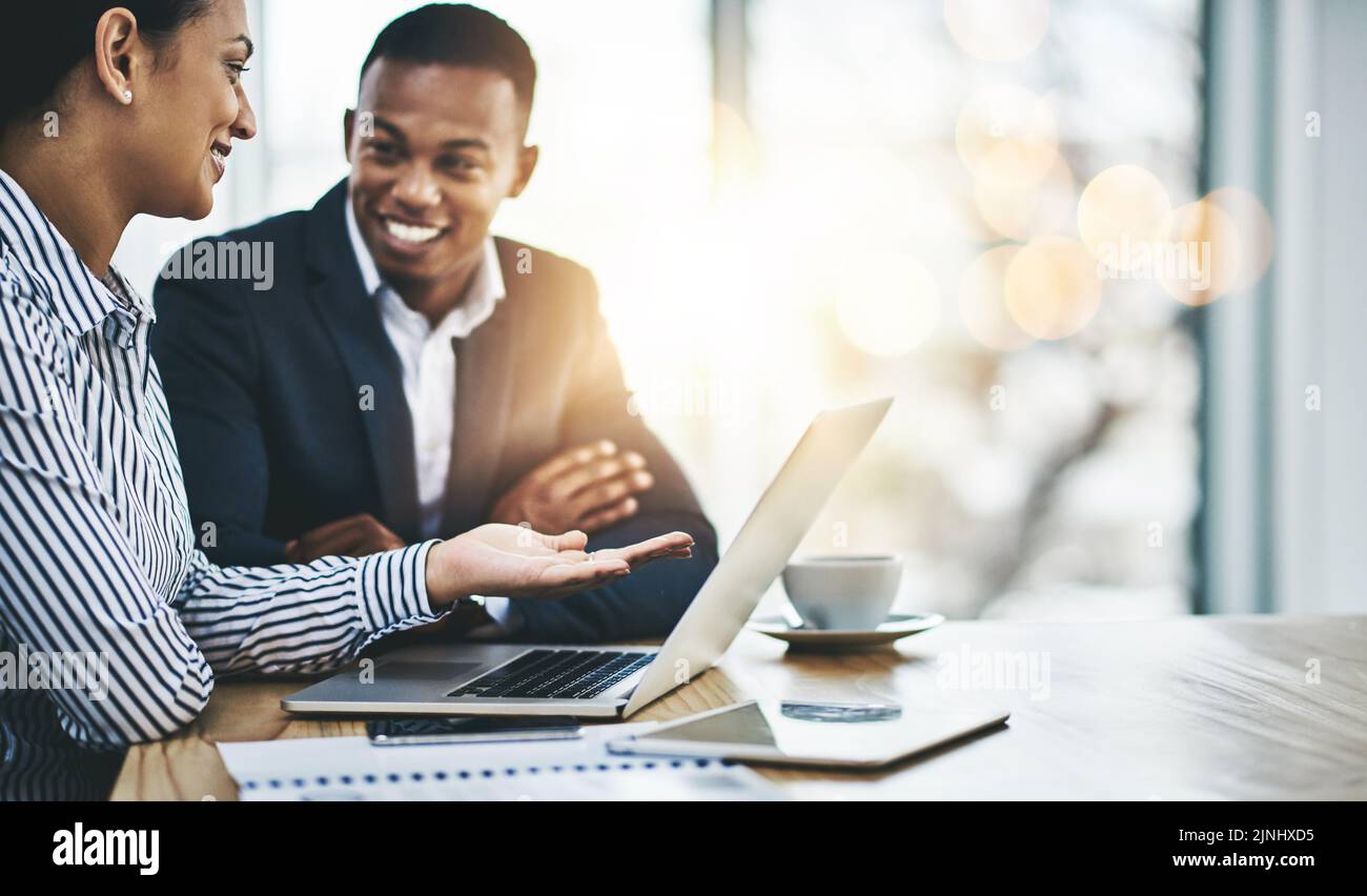 Great things happen when we work together. two businesspeople working ...