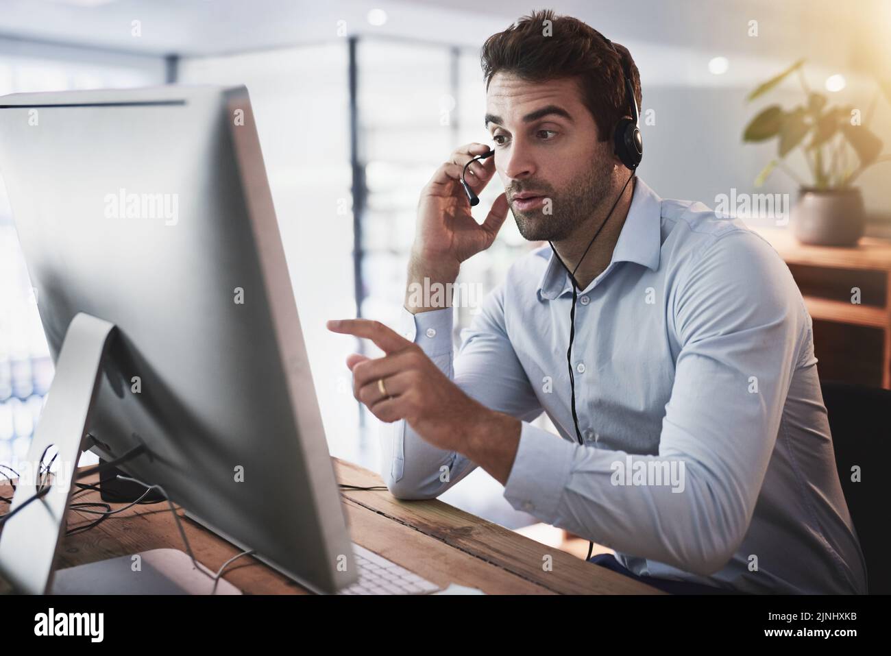 Giving careful instructions for a client to follow. a young call centre ...