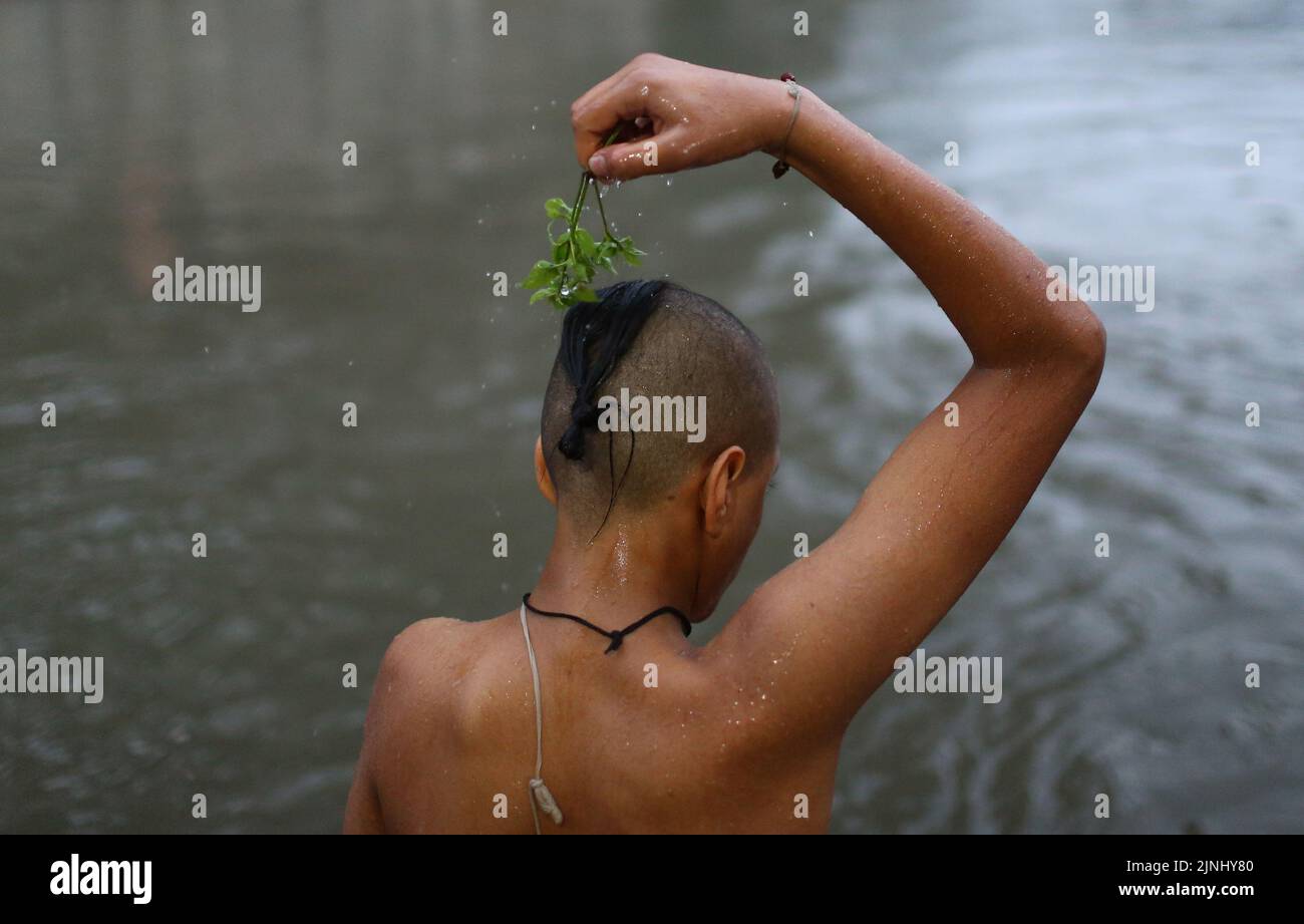 Kathmandu, Nepal. 12th Aug, 2022. A Hindu priest wearing sacred threads ...
