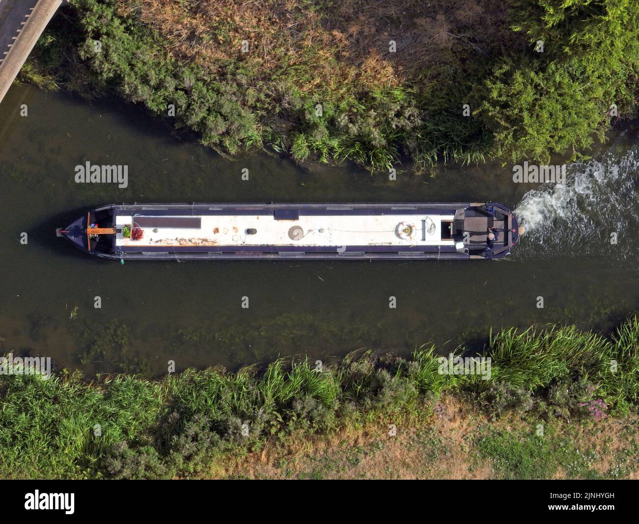 A narrow boat makes its way up the Kings Dike, near Peterborough ...