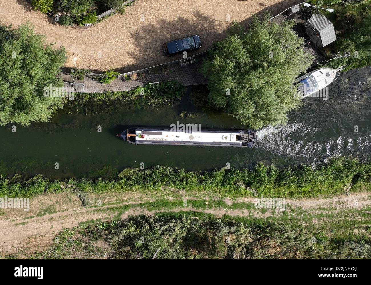 A narrow boat makes its way up the Kings Dike, near Peterborough ...