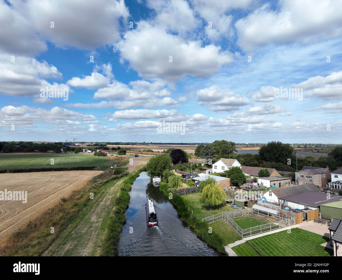A narrow boat makes its way up the Kings Dike, near Peterborough ...