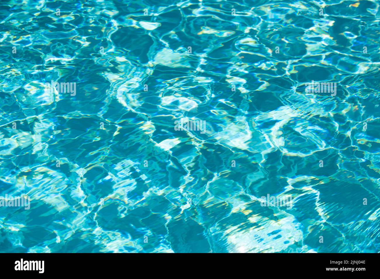 Background of blue water in swimming pool with sun reflection, ripple ...