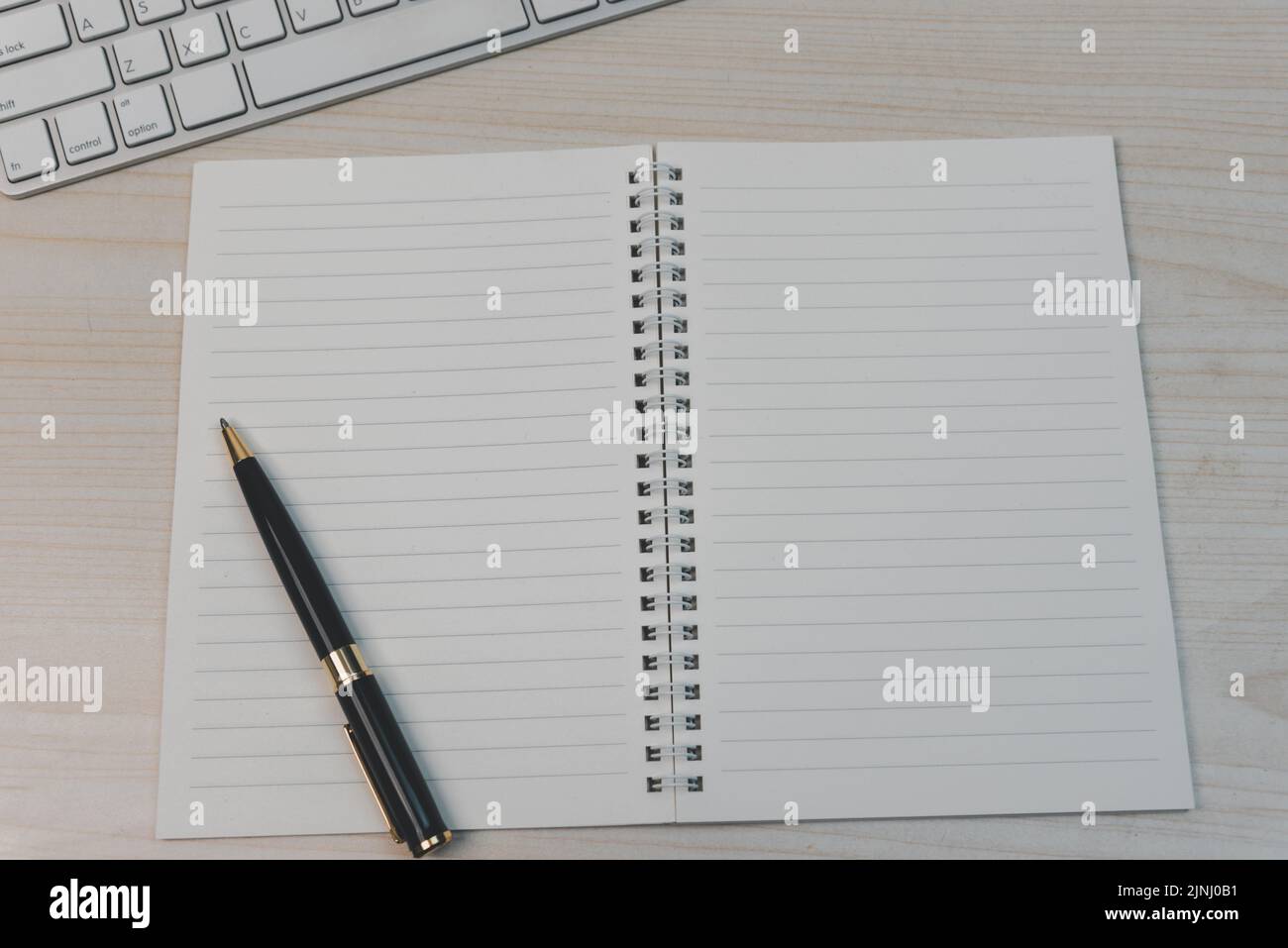 keyboard computer and book with pen on desk Stock Photo - Alamy