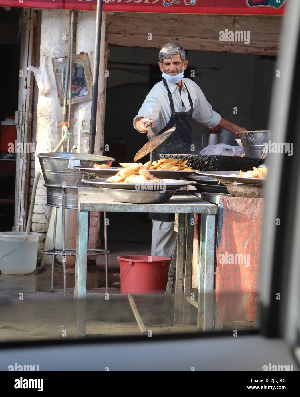 Old man selling somosa in Market Stock Photo - Alamy