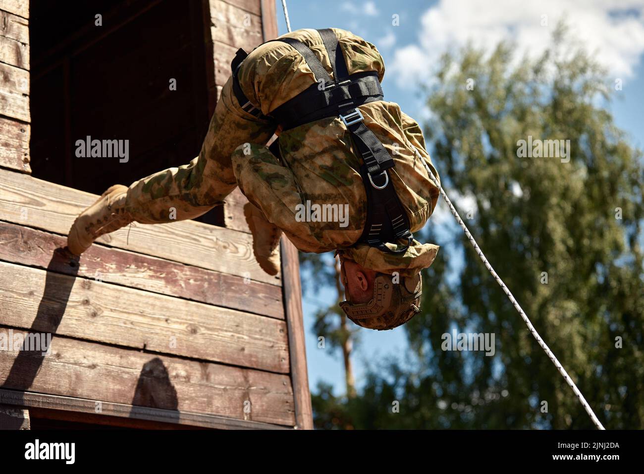 Special forces operator during assault rappeling with weapons. Soldiers ...