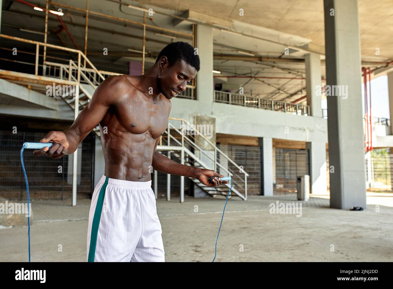 Black young sportsman working out with jumping rope outdoors Stock ...