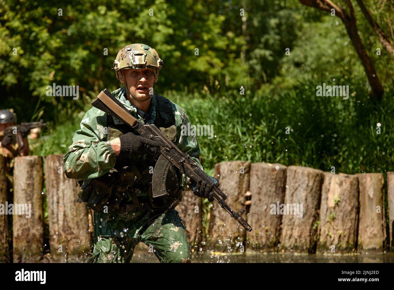 Special forces soldier with weapon take part in military maneuver. War ...