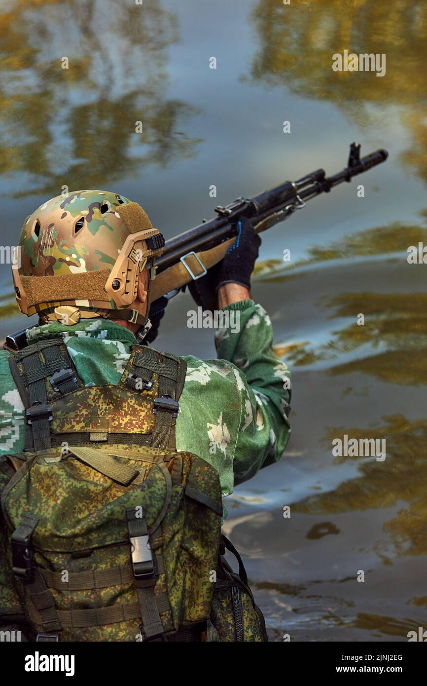 Special forces soldier with weapon take part in military maneuver. War ...