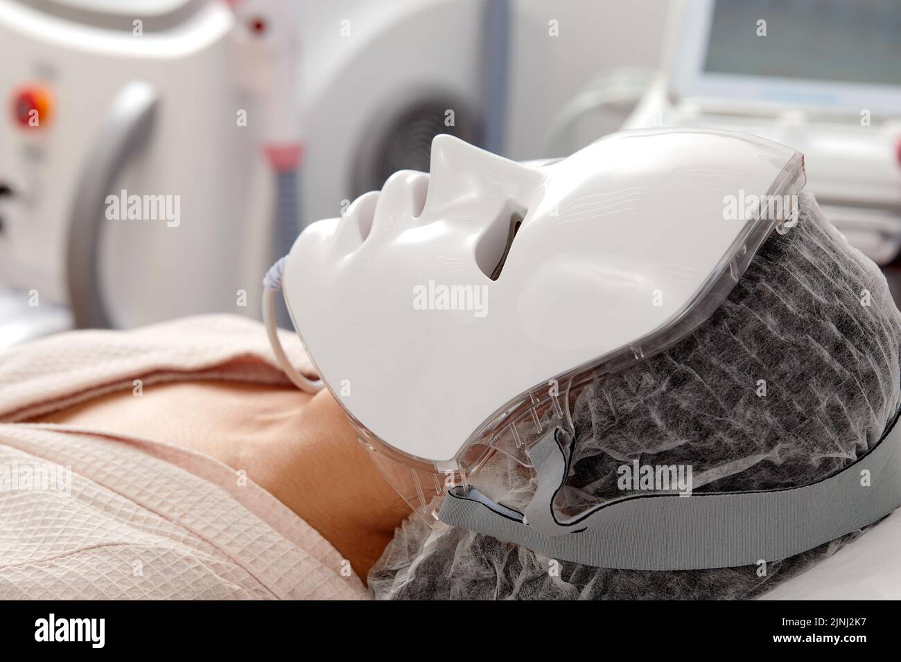 LED light anti-aging mask for facial skin care in a spa slow motion. A ...