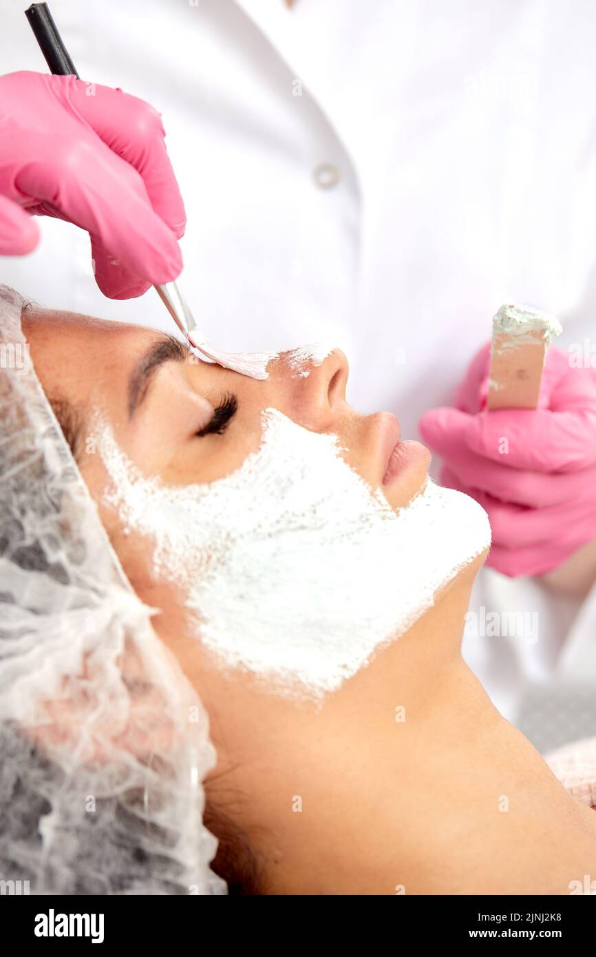 Satisfied young Caucasian beautiful woman uses services of professional ...