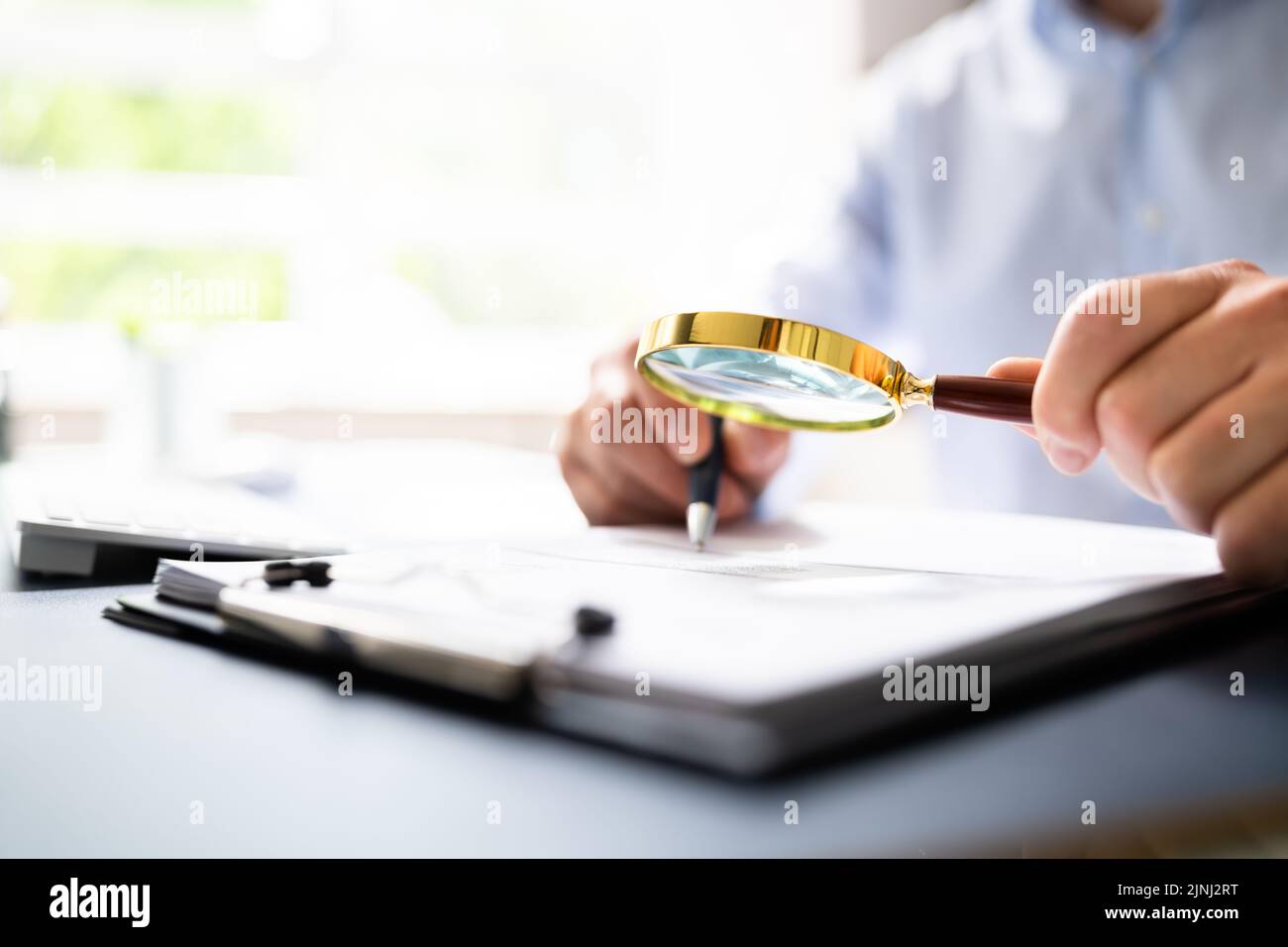 Auditor Doing Tax Fraud Investigation Using Magnifying Glass Stock ...