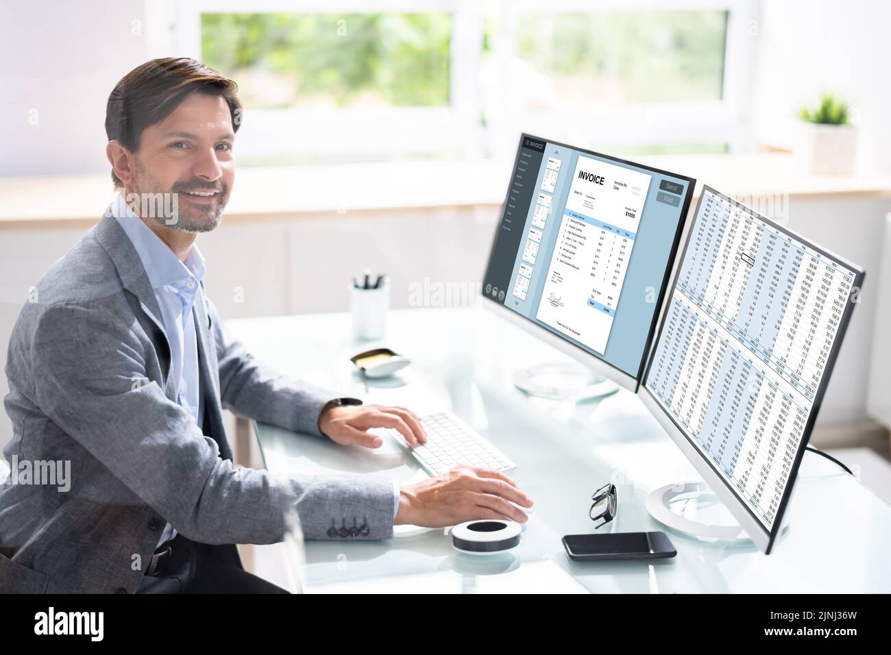 Looking At Invoice And Spreadsheet On Computer At Work Stock Photo - Alamy
