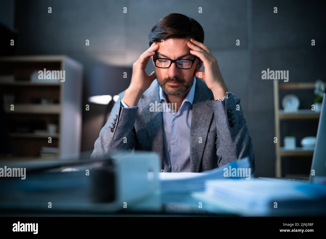 Stressed Tax Advisor With Headache. Sad Accountant Stock Photo - Alamy