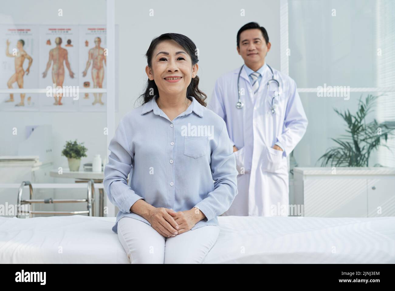 Pretty senior patient posing for photography with wide smile while ...