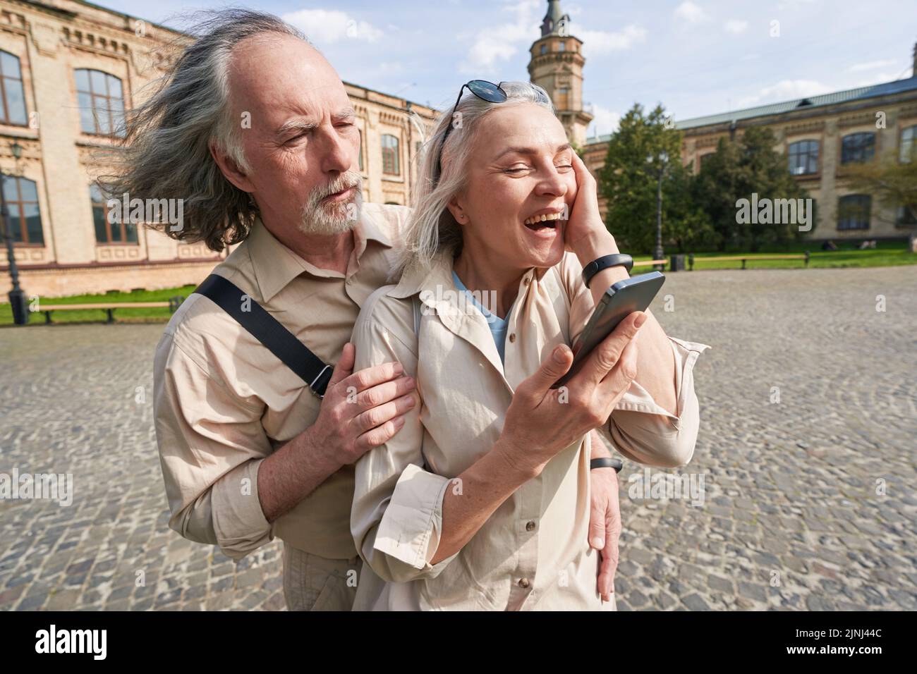 Serious male person standing close to his wife Stock Photo - Alamy