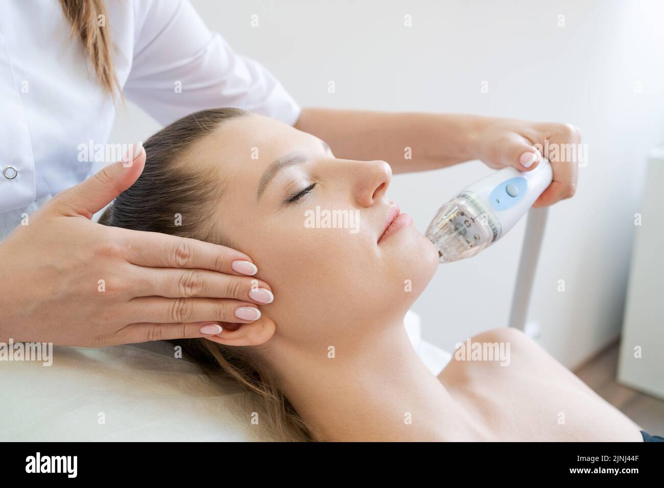 Handle radio frequency apparatus on chin woman's face during skin ...