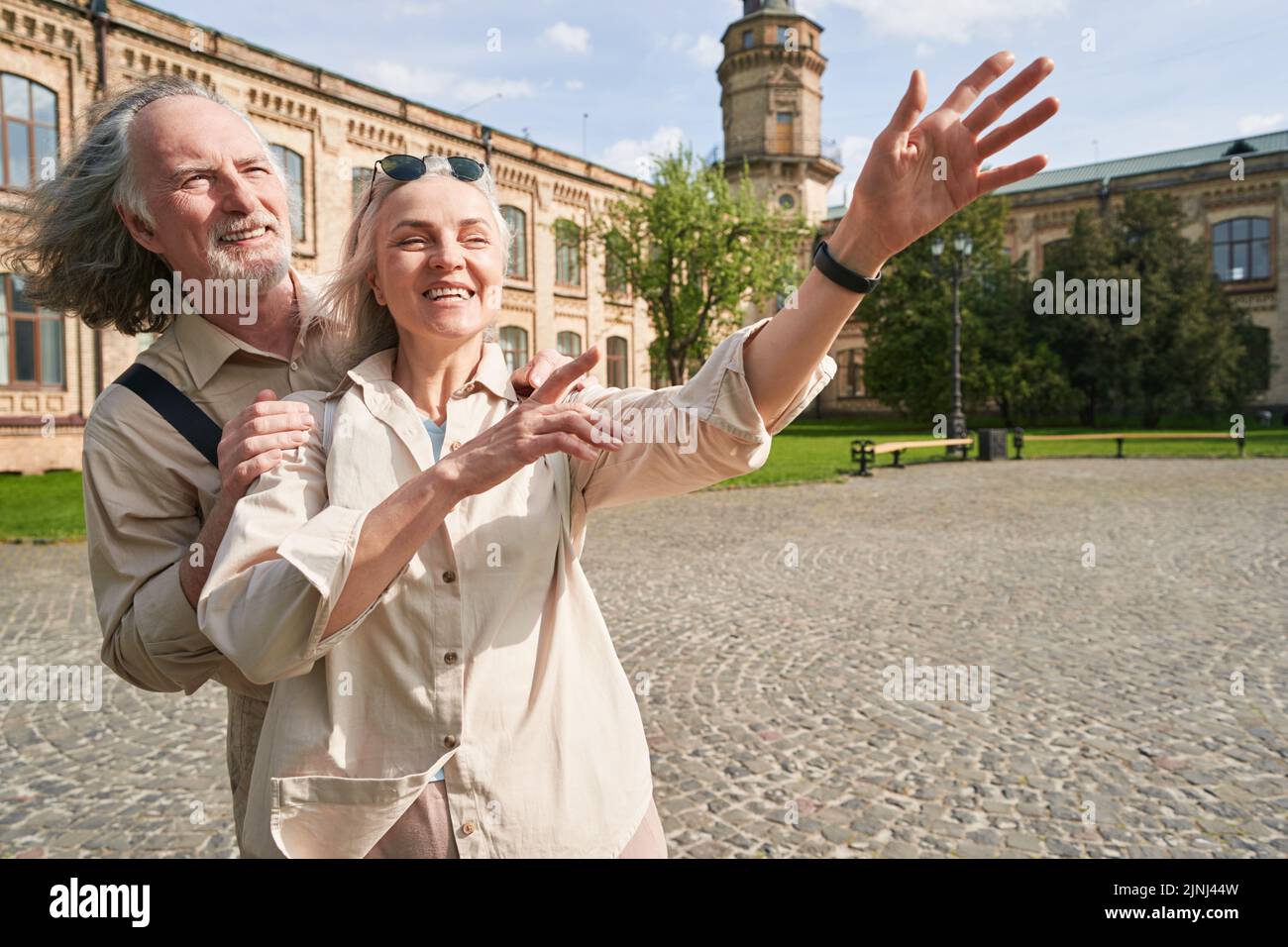 Positive delighted mature couple enjoying sightseeing together Stock ...