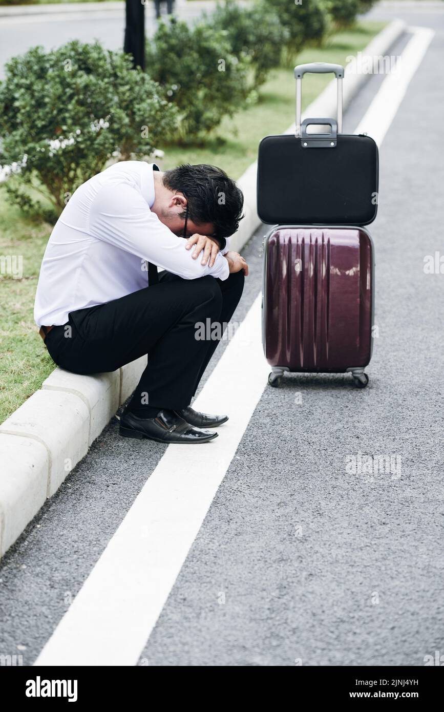 Frustrated man sitting on street hi-res stock photography and images ...