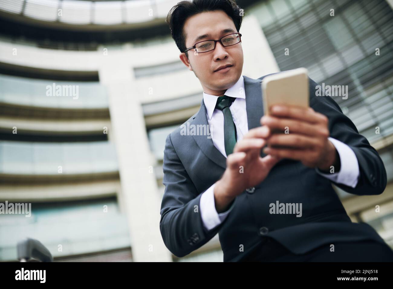 Asian businessman using browsing mobile hi-res stock photography and ...