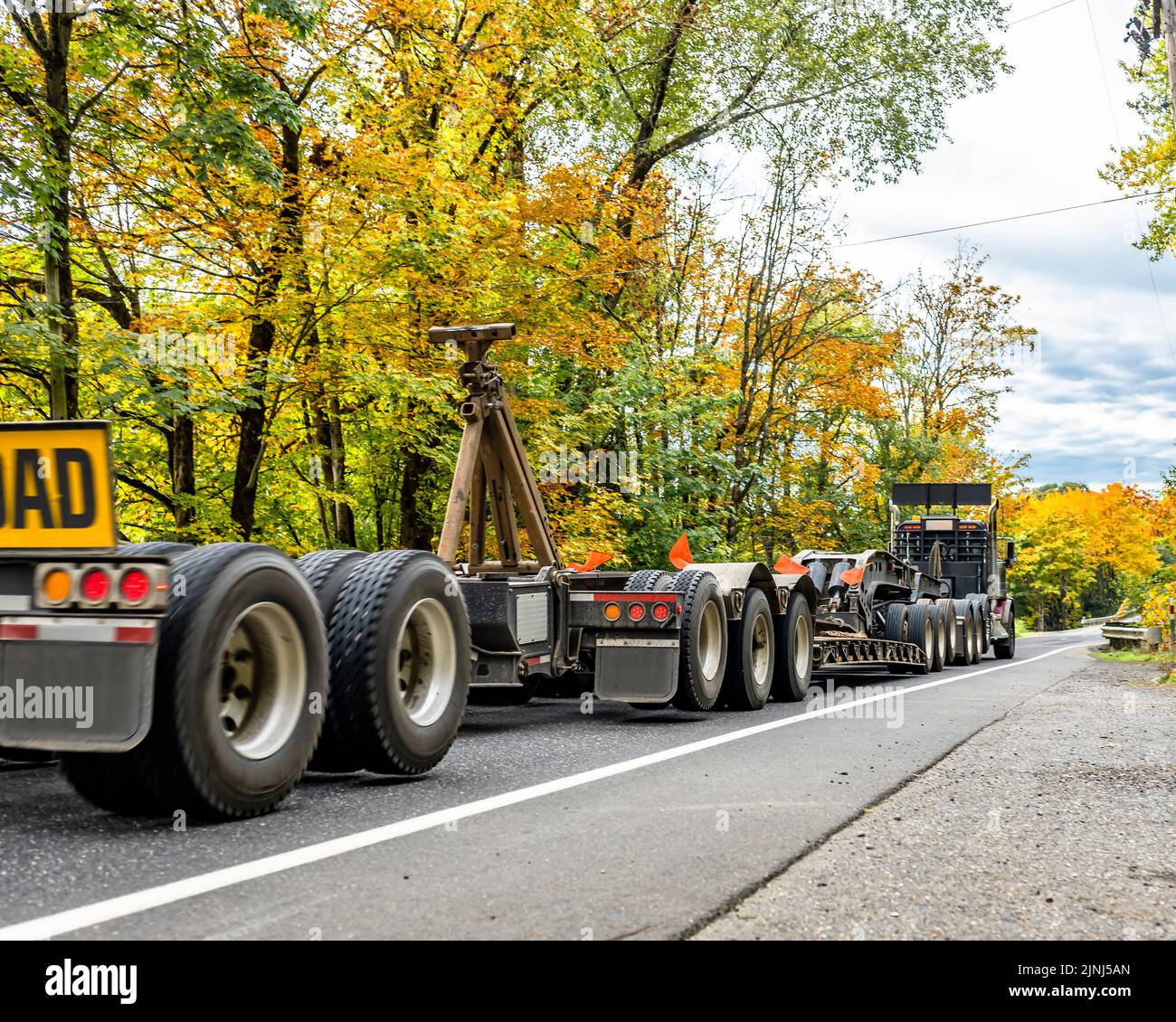 Industrial big rig hauler semi truck with oversize load sign ...
