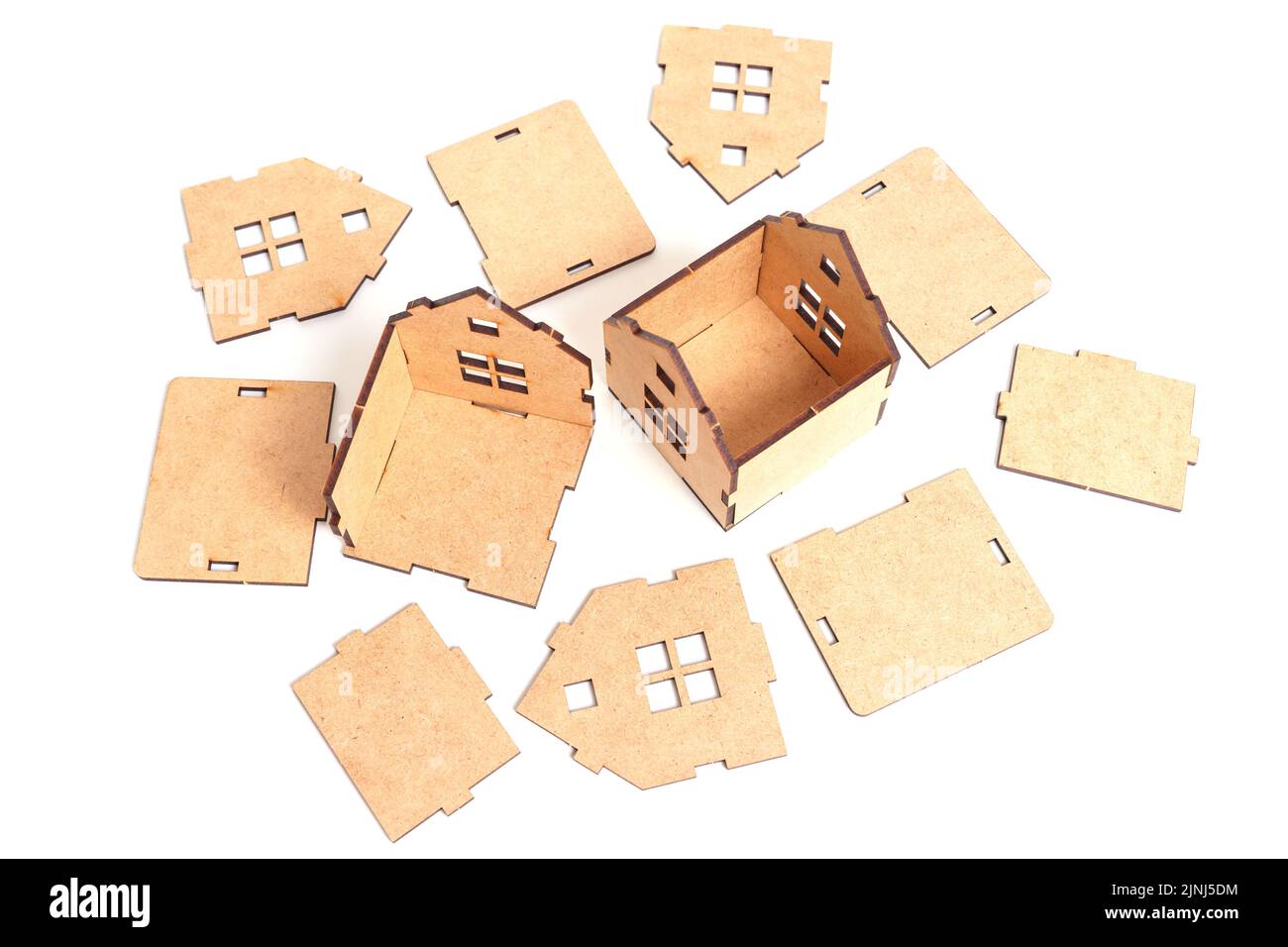 Top view of two self-assembly wooden toy houses with parts isolated on ...