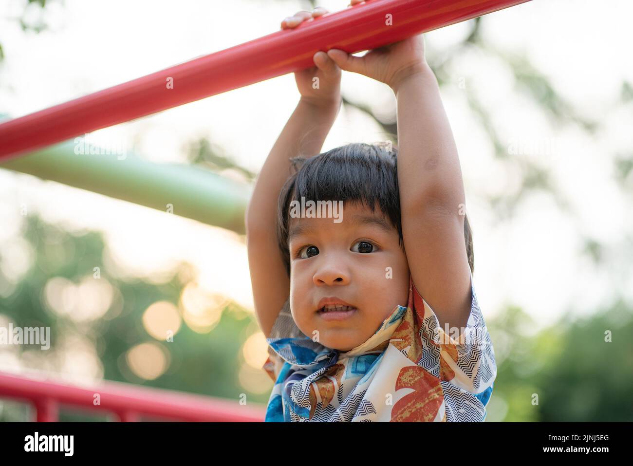 Little asian boy playing in colorful playground outdoor public park ...