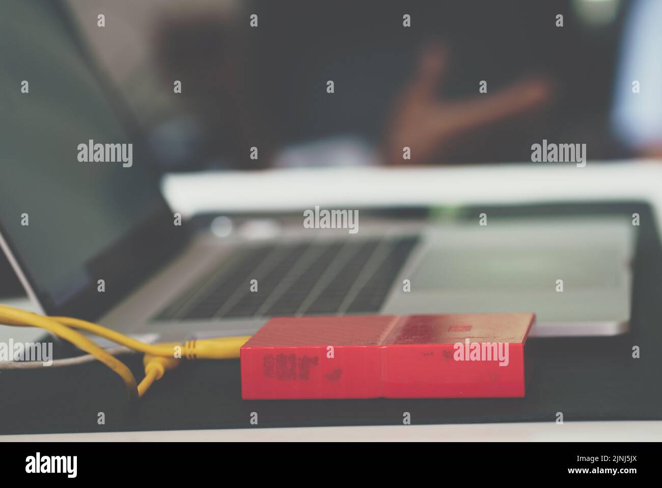 External hard drive connect to laptop computer working on table storage ...