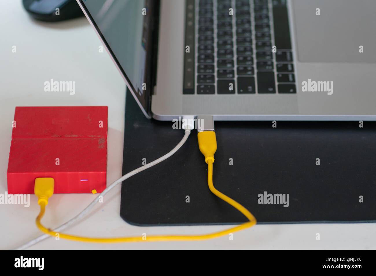 External hard drive connect to laptop computer working on table storage ...