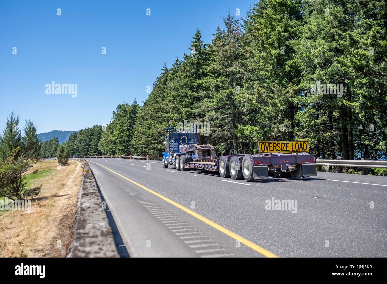 Blue classic industrial big rig semi truck tractor transporting heavy ...