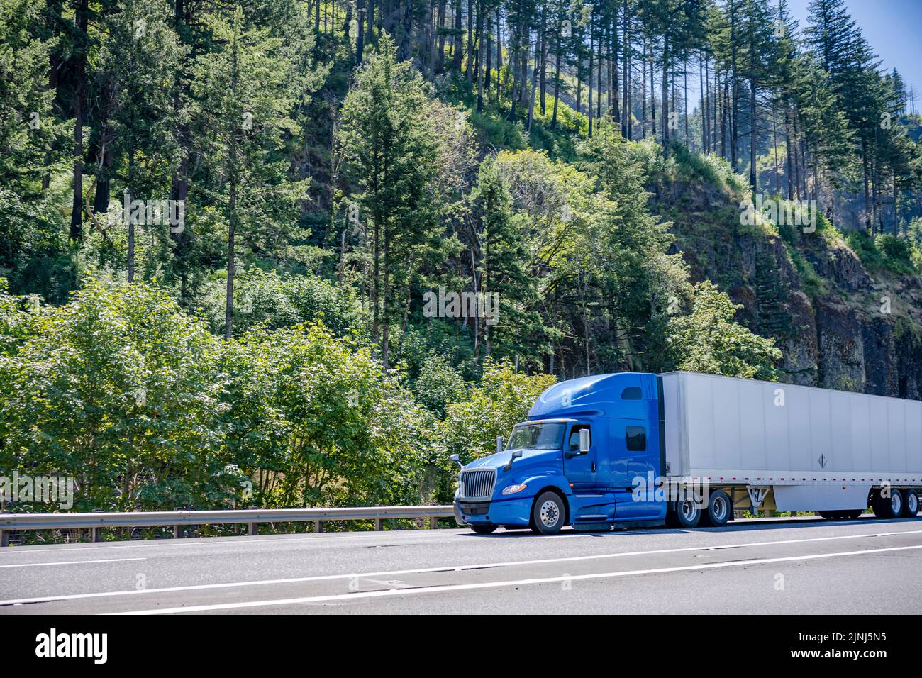 Bright blue industrial big rig semi truck with truck driver cab sleep ...