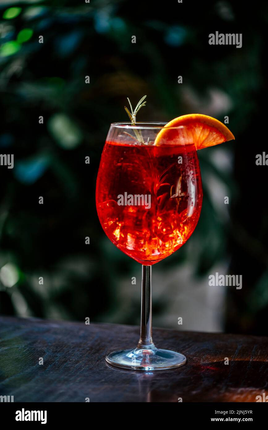 Aperol spritz cocktail garnish with grapefruit and rosemary in front of ...