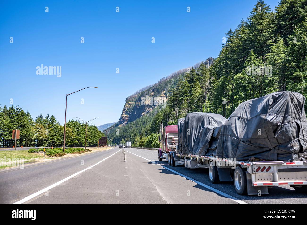 Industrial burgundy classic big rig semi truck tractor with extended ...