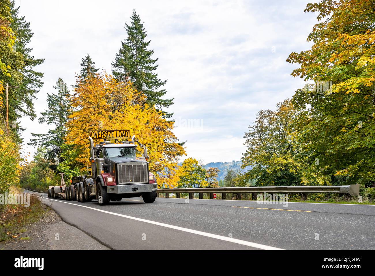 Industrial big rig hauler semi truck with oversize load sign ...