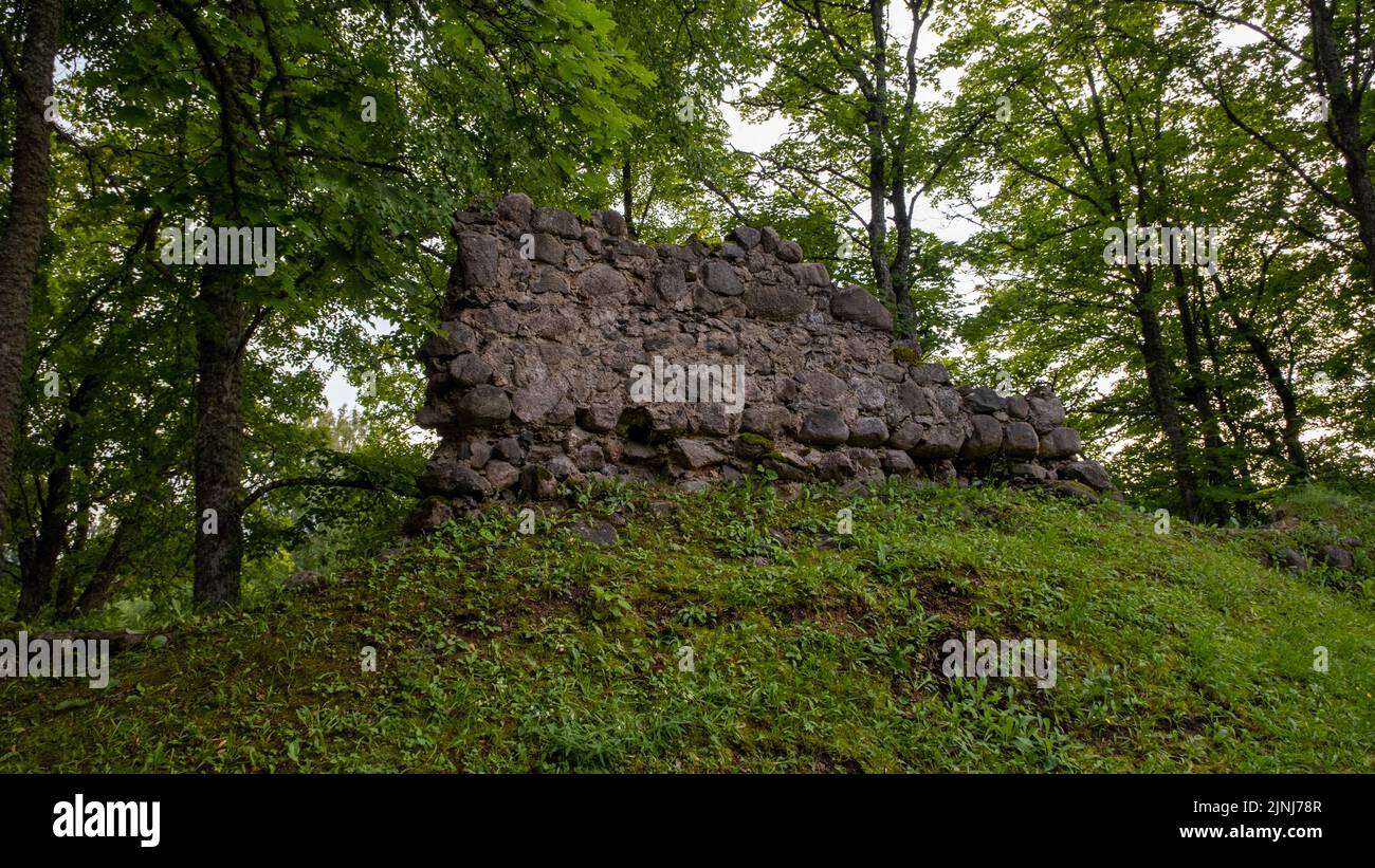 very old historic castle ruins at the top of the hill. summer day in ...