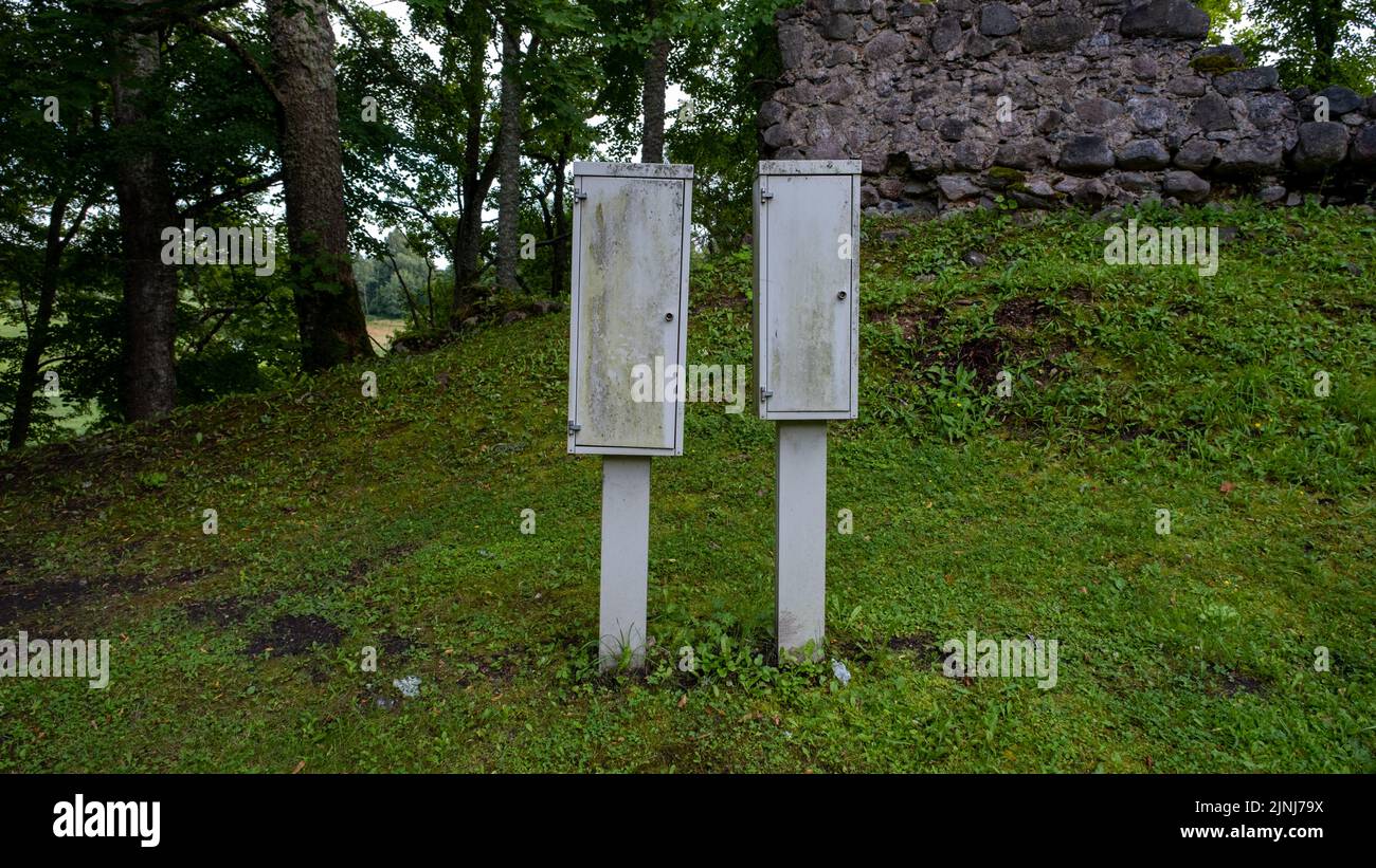 Two white electrical boxes outside, near the castle ruins Stock Photo ...