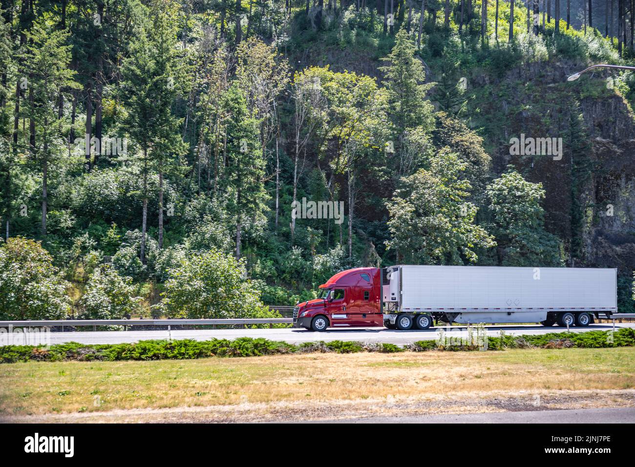 Dark red industrial big rig semi truck with high roof cab transporting ...